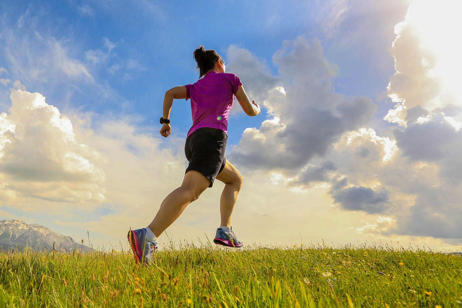 healthy young woman trail runner running on beautiful mountain peak ...